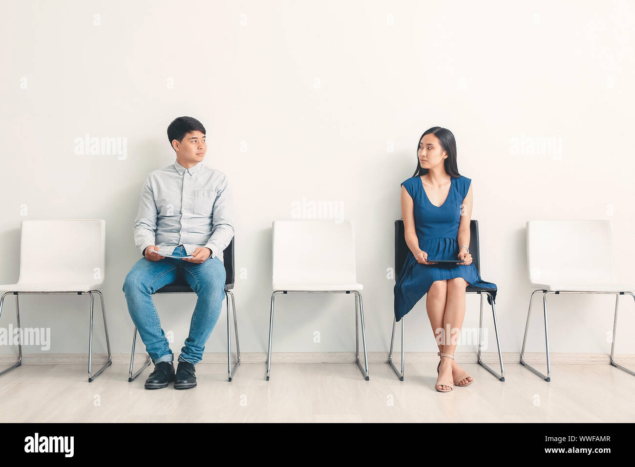 Young people waiting for job interview indoors Stock Photo - Alamy