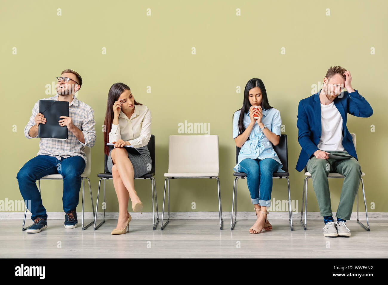 Young people waiting for job interview indoors Stock Photo - Alamy