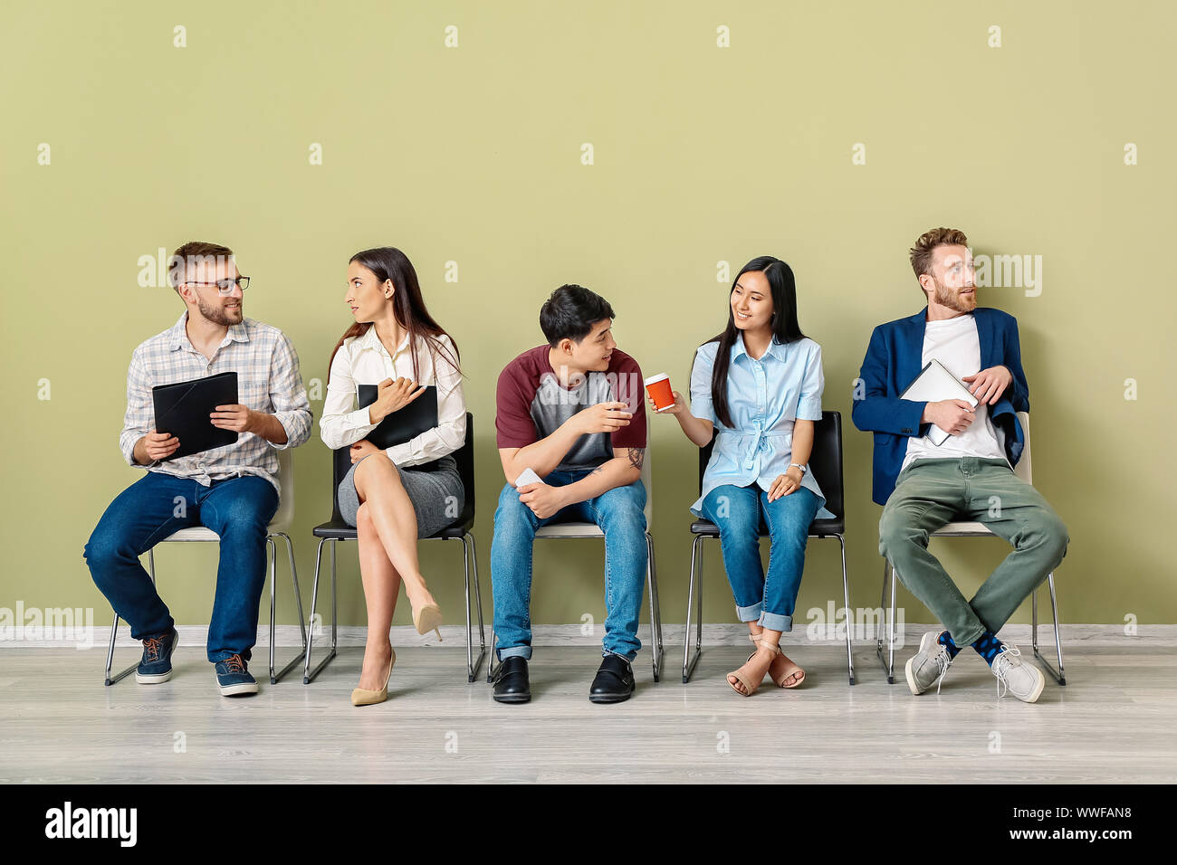 Young people waiting for job interview indoors Stock Photo - Alamy