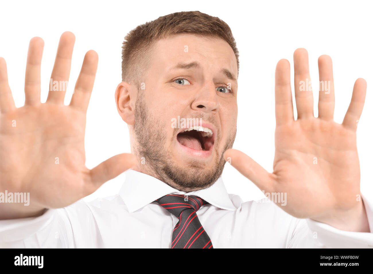 Businessman having panic attack on white background Stock Photo - Alamy