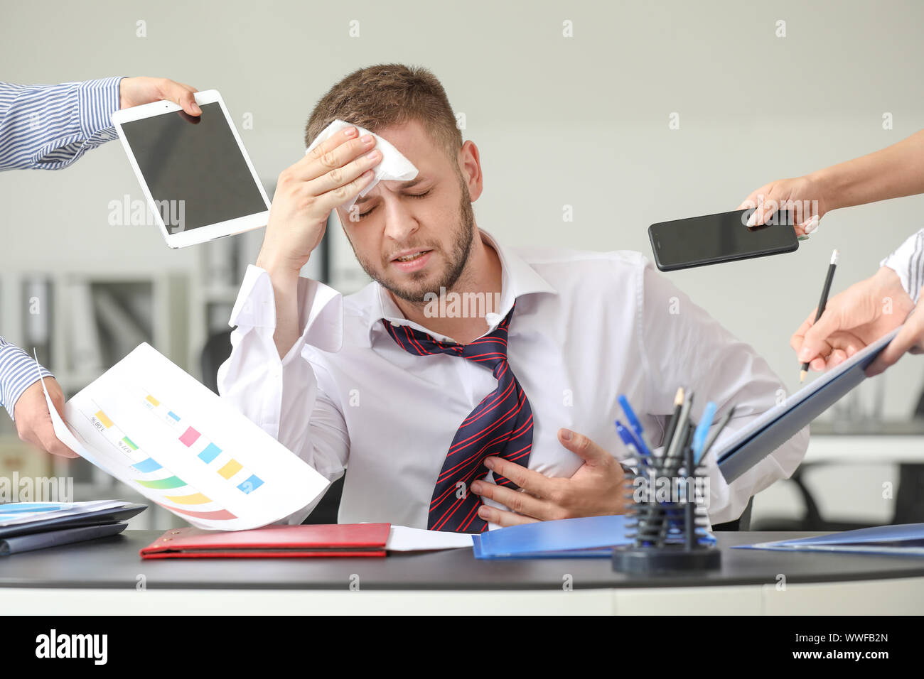 Overworked businessman having panic attack in office Stock Photo - Alamy