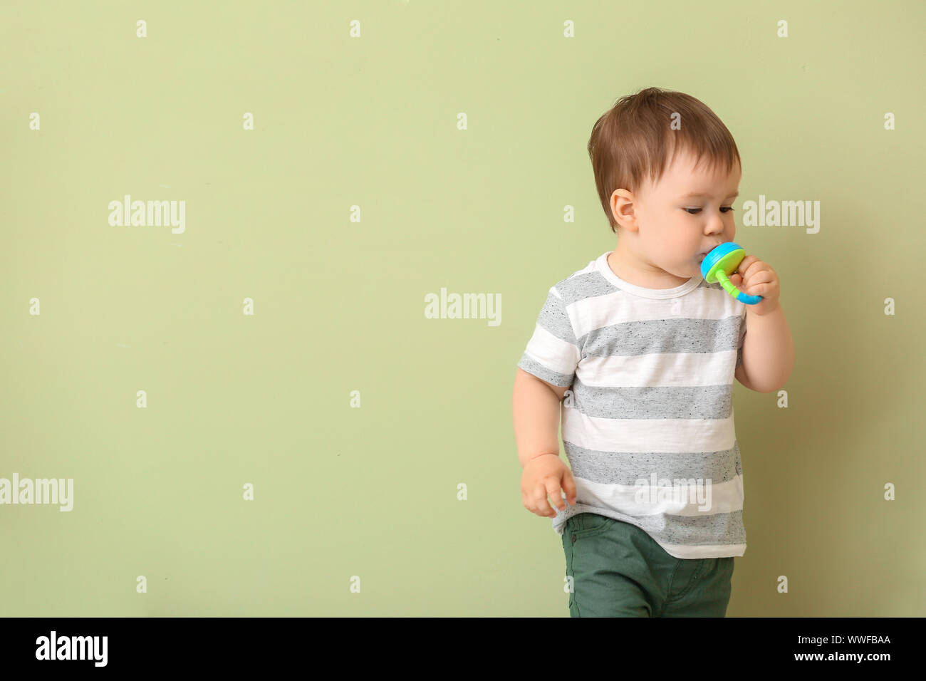 Cute little boy with nibbler on color background Stock Photo - Alamy