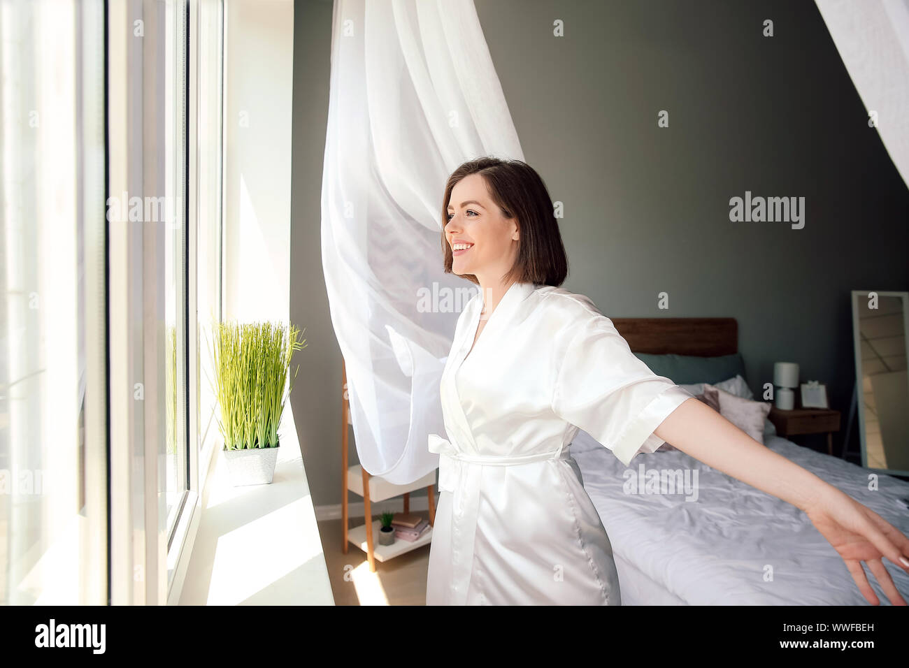 Morning of beautiful young woman near window Stock Photo - Alamy
