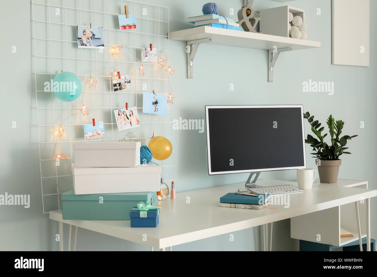 Workplace with mood board and computer in modern room Stock Photo - Alamy