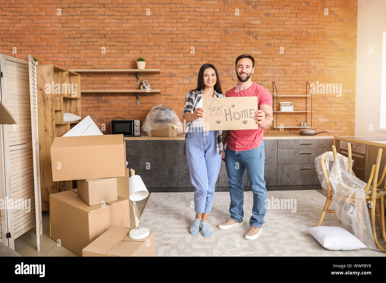 Happy young couple after moving into new house Stock Photo - Alamy