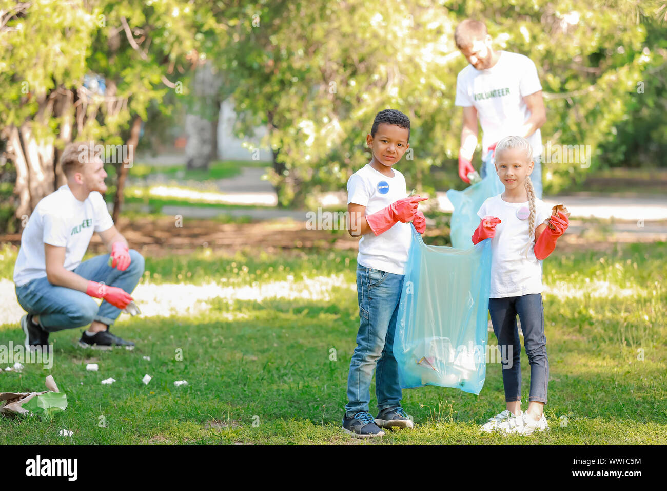 Little volunteers gathering garbage in park Stock Photo - Alamy
