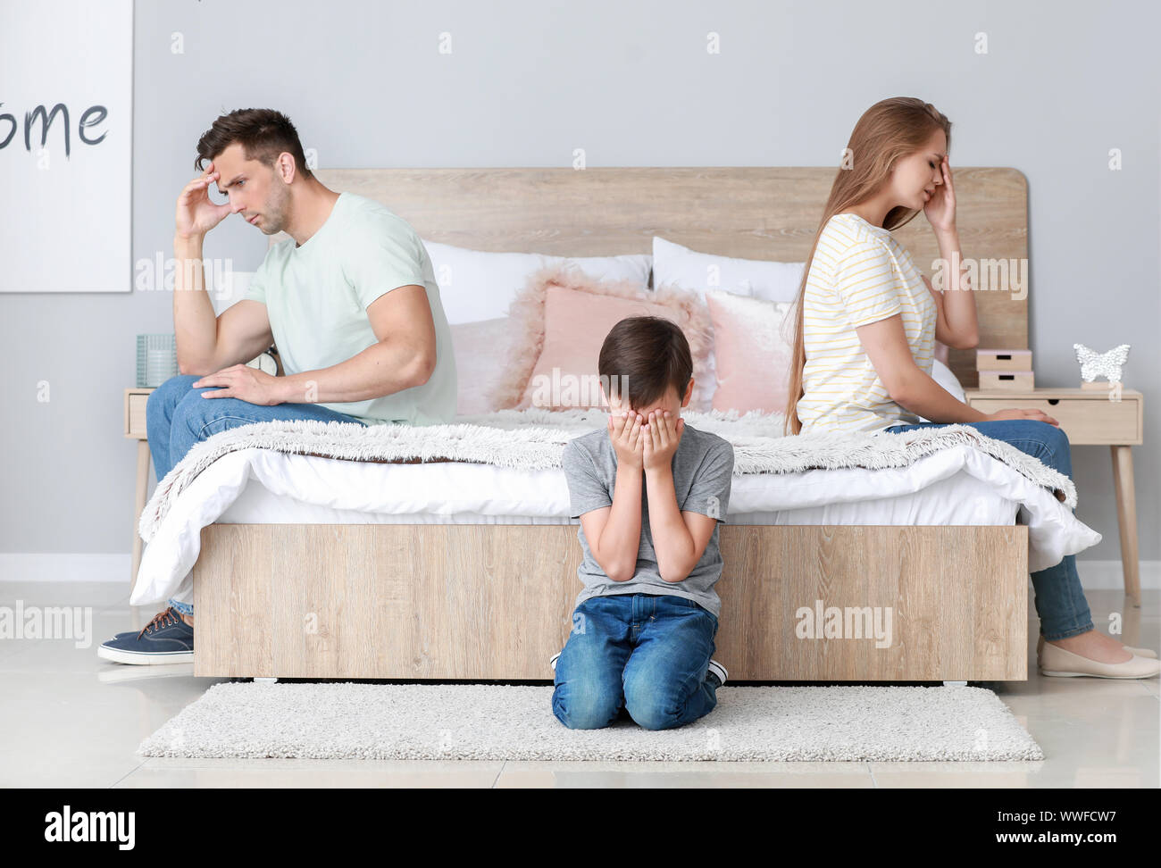 Sad family in bedroom after quarrel Stock Photo - Alamy
