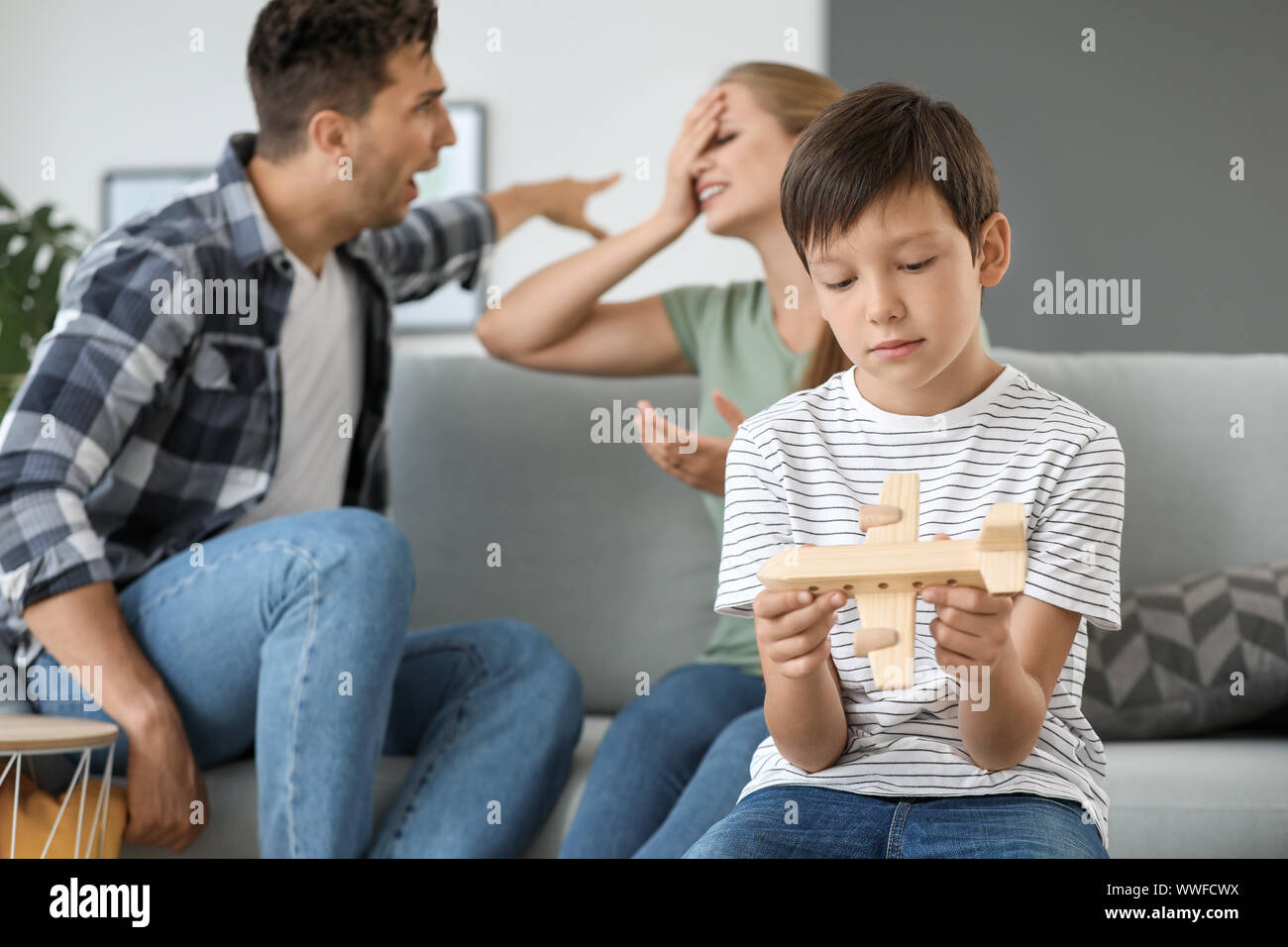 Little boy and his quarreling parents at home Stock Photo - Alamy