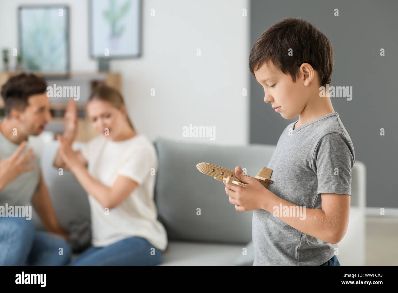 Sad little boy and his quarreling parents at home Stock Photo - Alamy
