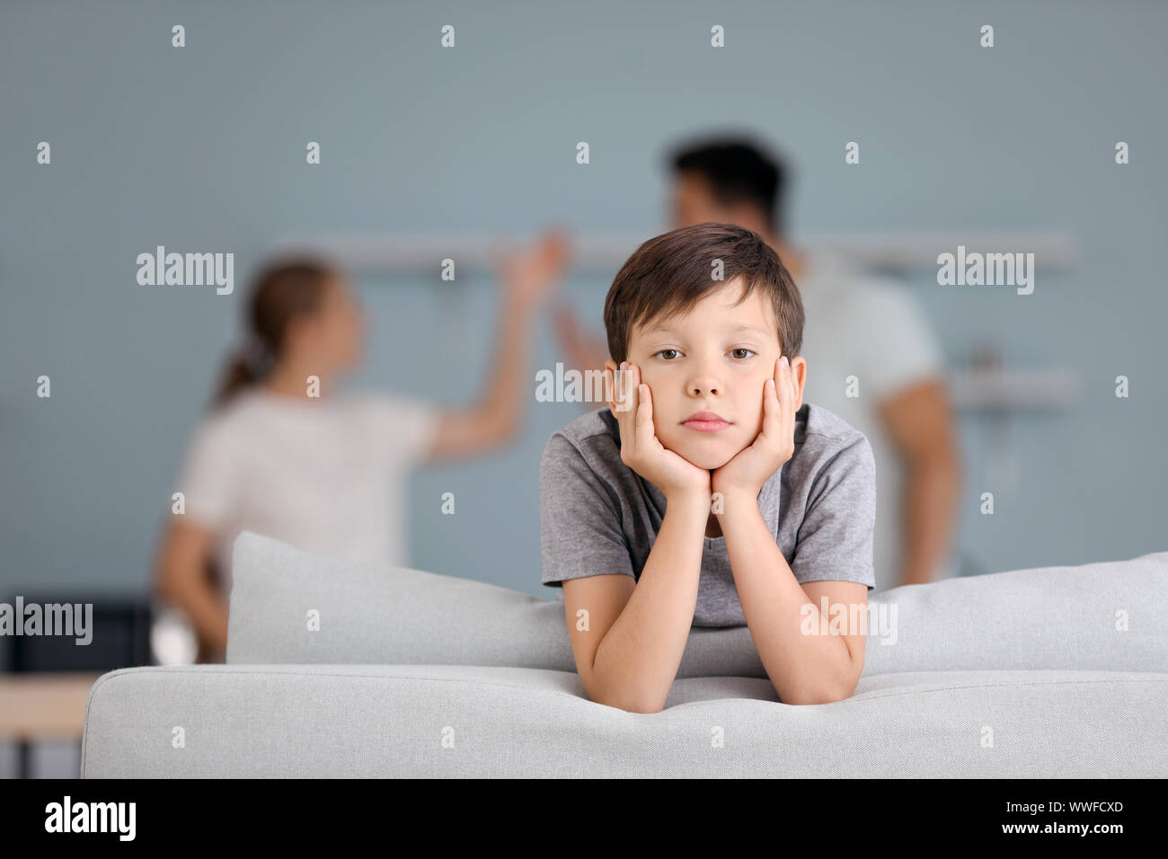 Sad little boy and his quarreling parents at home Stock Photo - Alamy