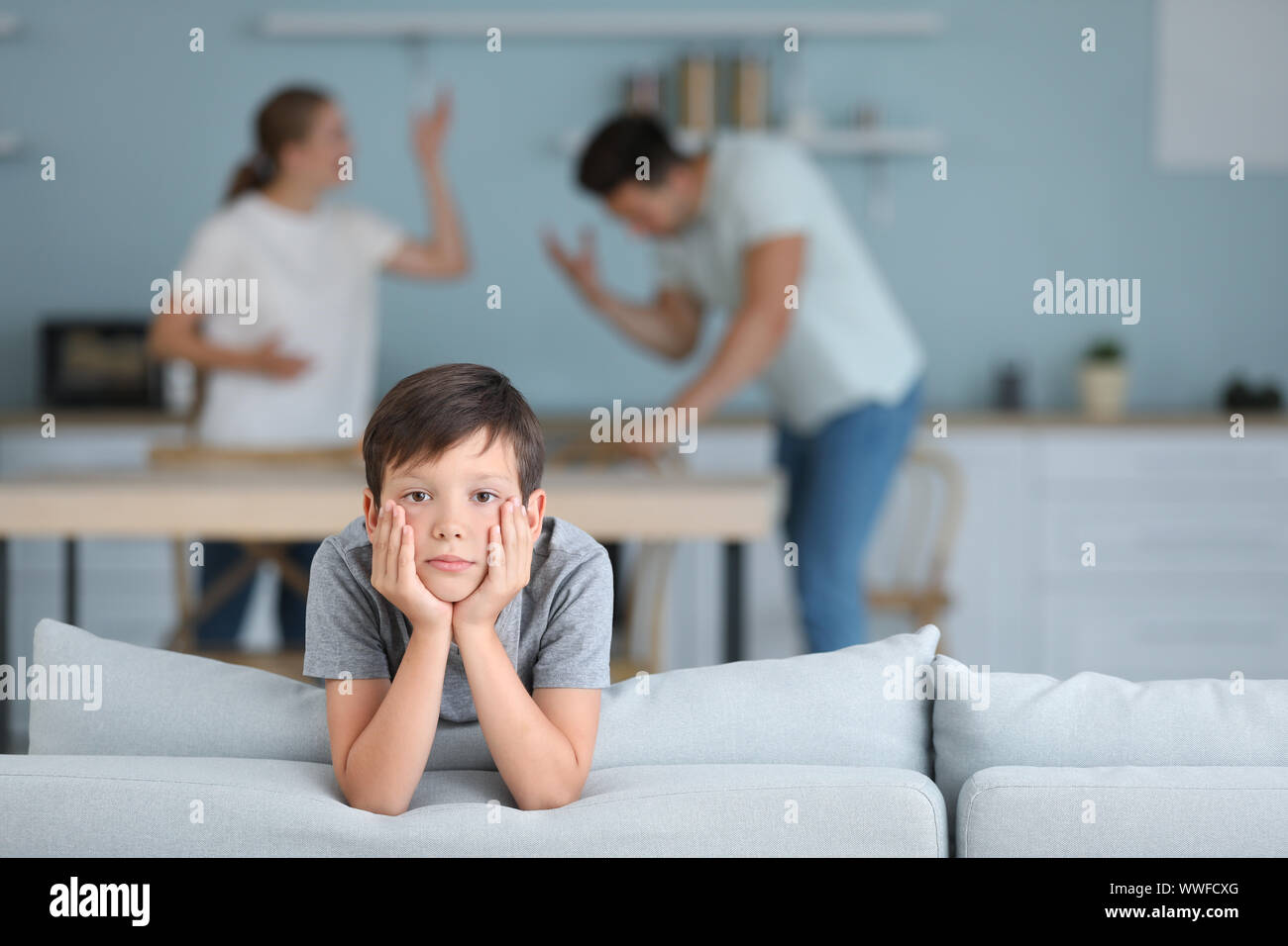 Sad little boy and his quarreling parents at home Stock Photo - Alamy
