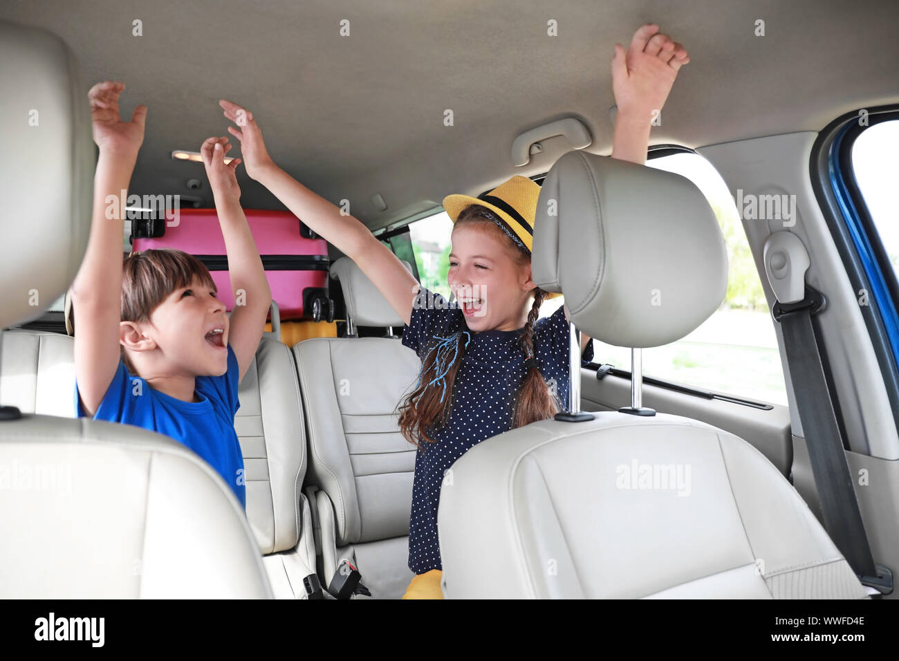 Happy children sitting in car Stock Photo - Alamy