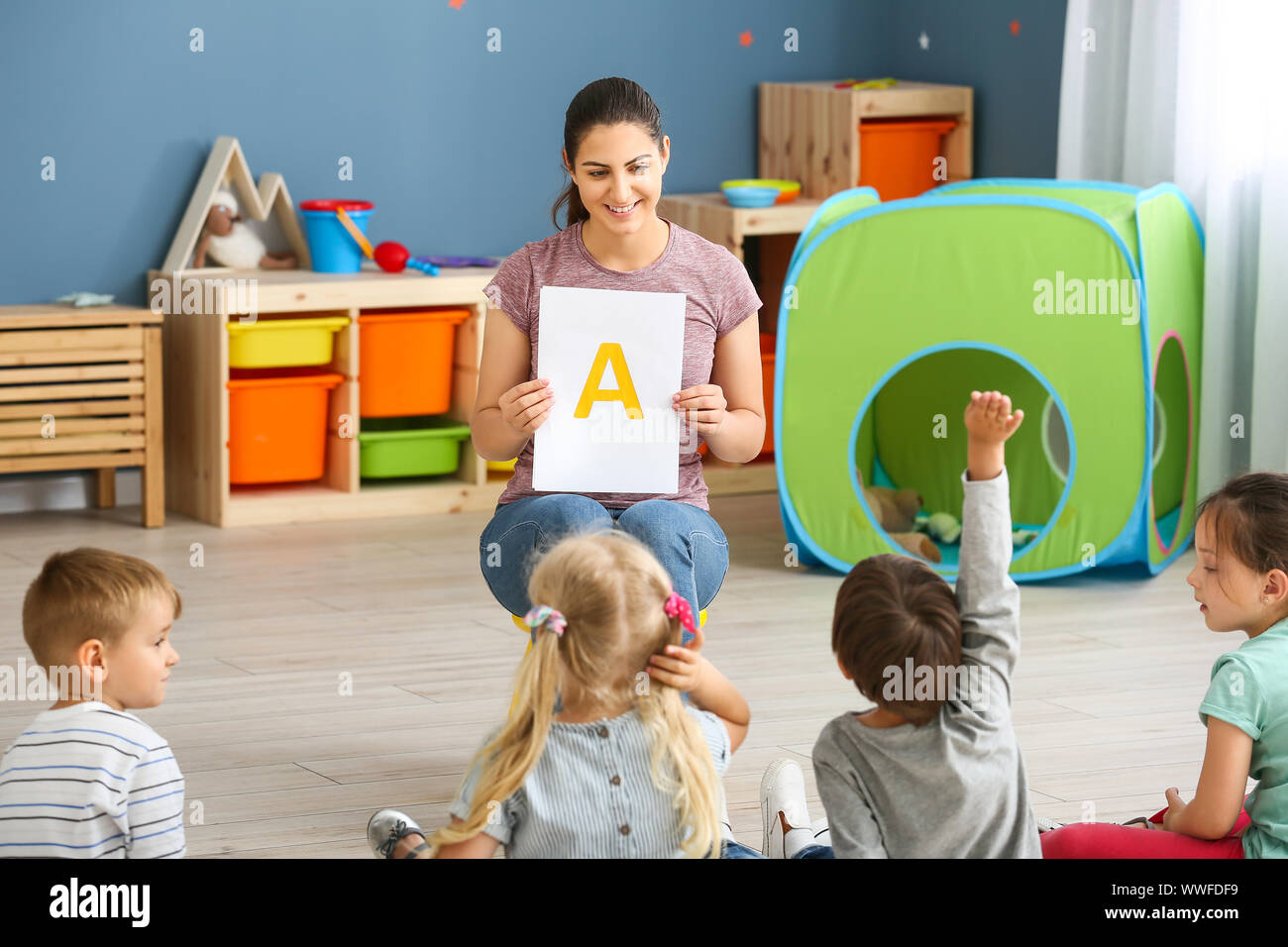 Cute little children learning letters in kindergarten Stock Photo - Alamy