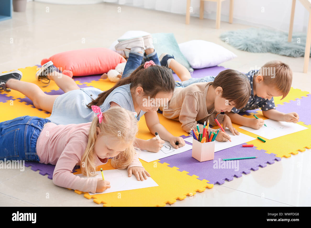 Cute little children drawing in kindergarten Stock Photo - Alamy