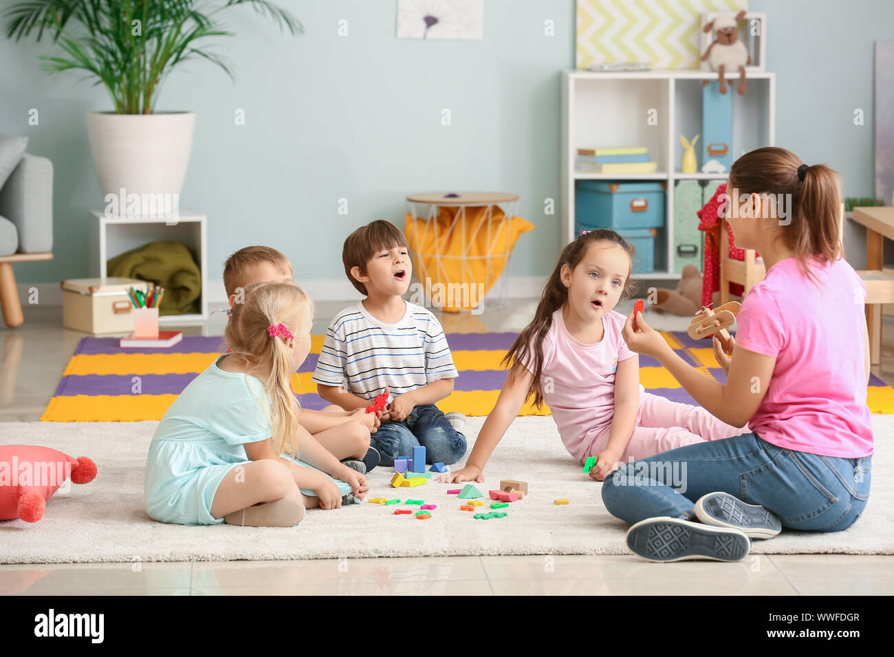 Cute little children learning letters in kindergarten Stock Photo - Alamy