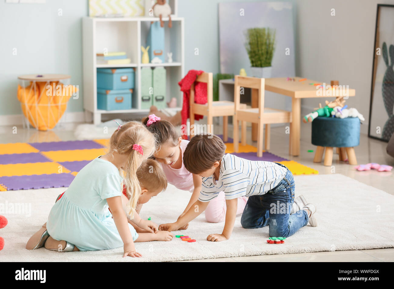 Cute little children playing in kindergarten Stock Photo - Alamy