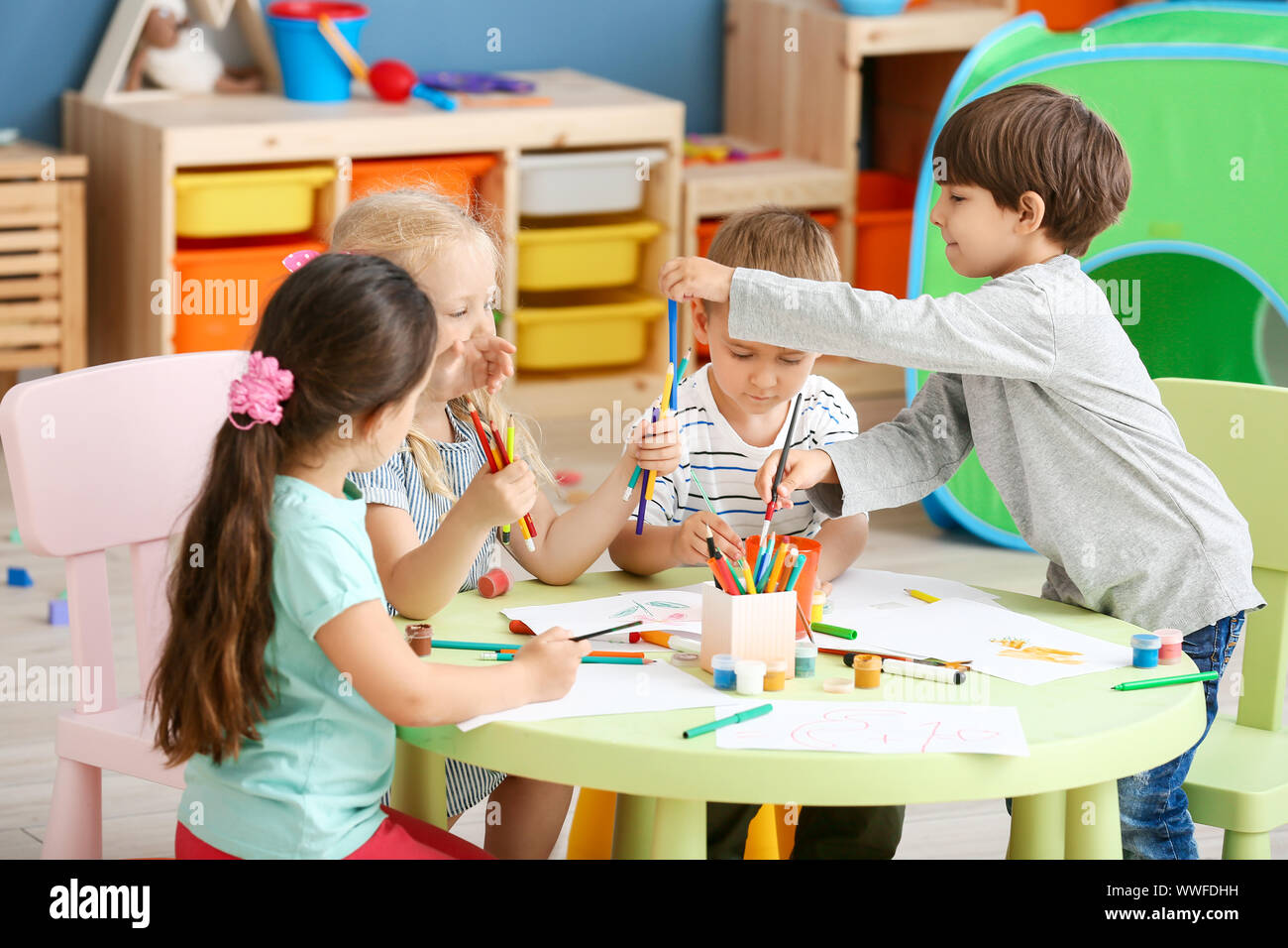 Cute little children drawing in kindergarten Stock Photo - Alamy