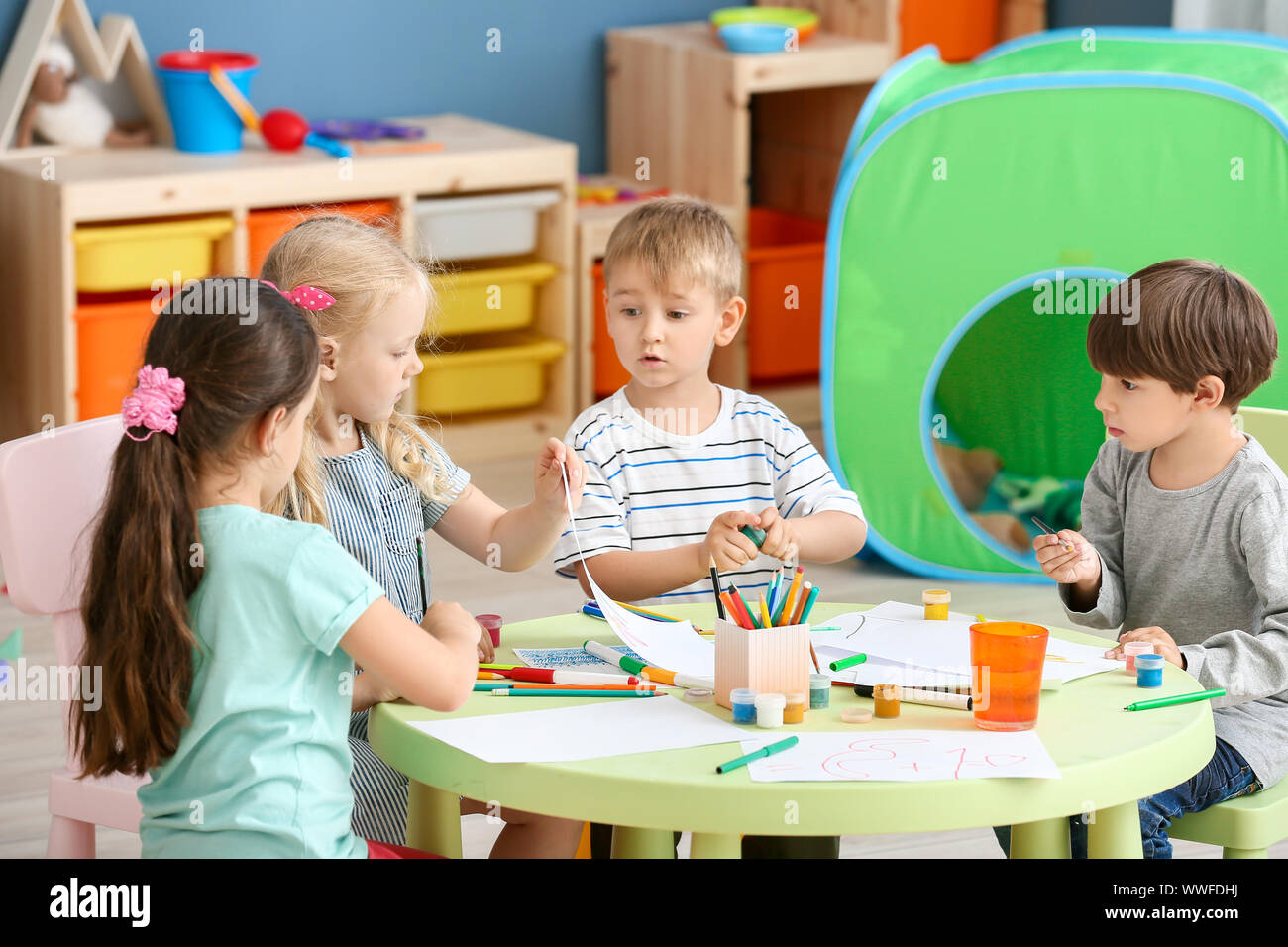 Cute little children drawing in kindergarten Stock Photo - Alamy
