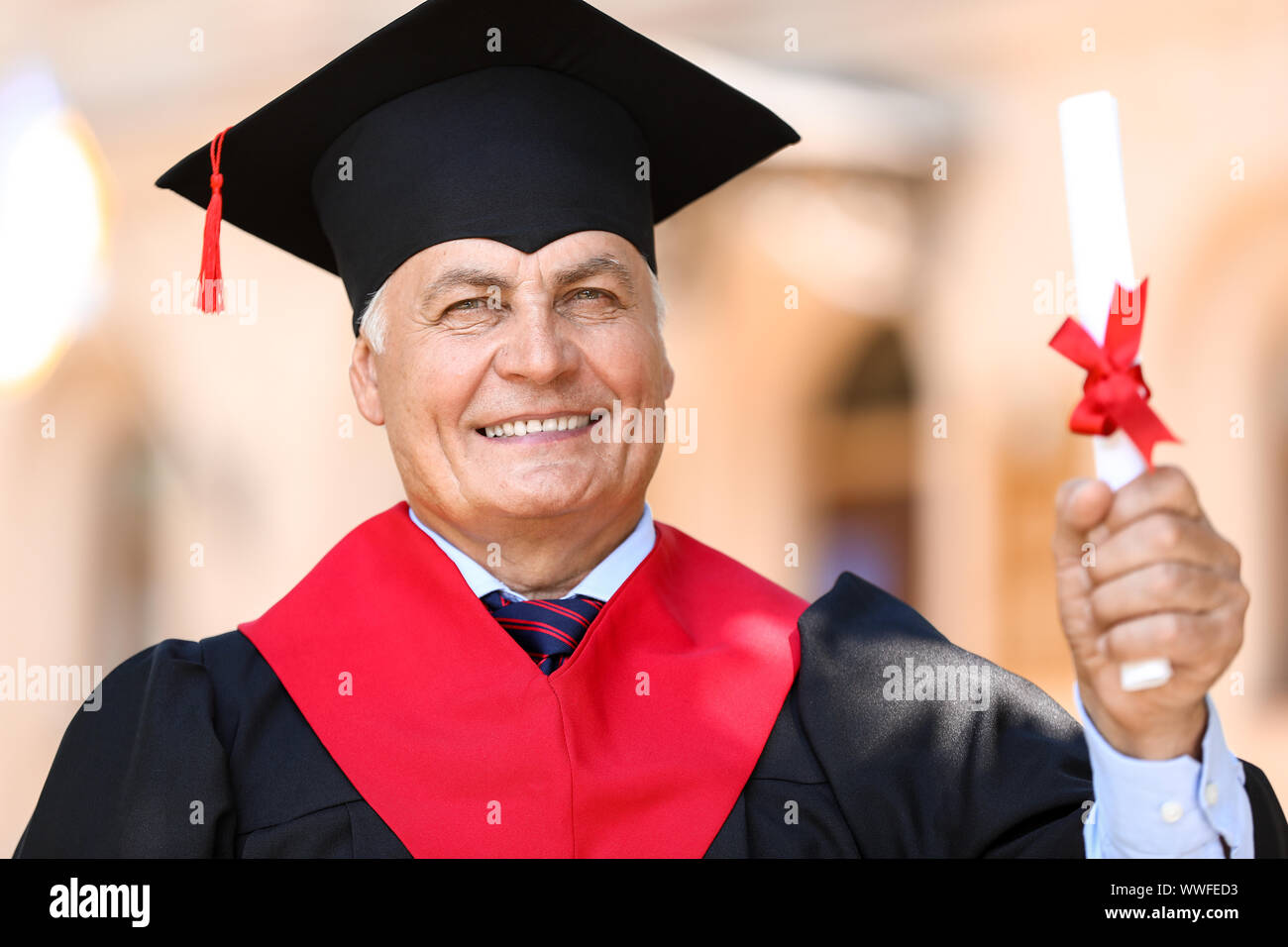 Mature man in bachelor robe outdoors Stock Photo - Alamy