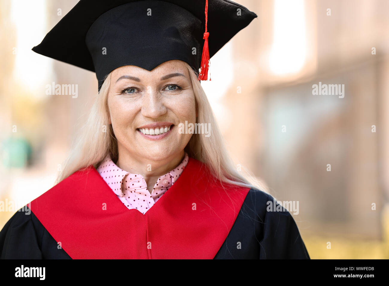 Mature woman in bachelor robe outdoors Stock Photo - Alamy