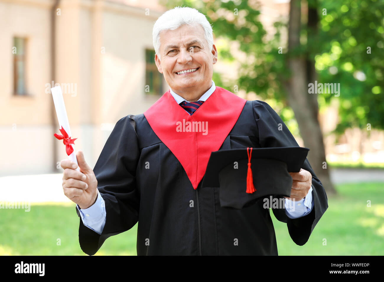 Mature man in bachelor robe outdoors Stock Photo - Alamy