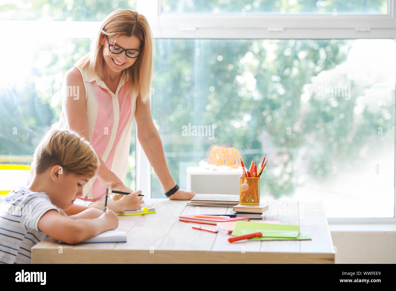 Teacher helping children hi-res stock photography and images - Alamy Teacher helping children hi-res stock photography and images - Alamy
