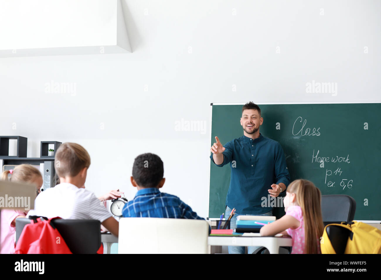 Teacher conducting lesson in classroom Stock Photo - Alamy