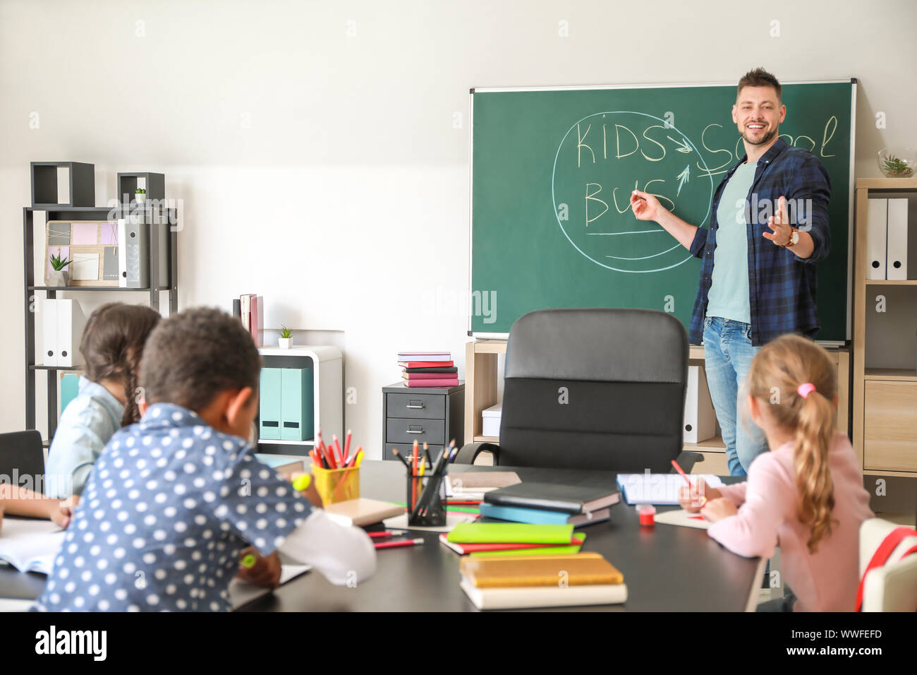 Teacher conducting lesson in classroom Stock Photo - Alamy