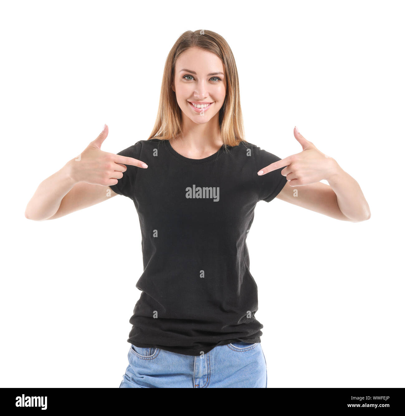 Woman pointing at her t-shirt against white background Stock Photo - Alamy