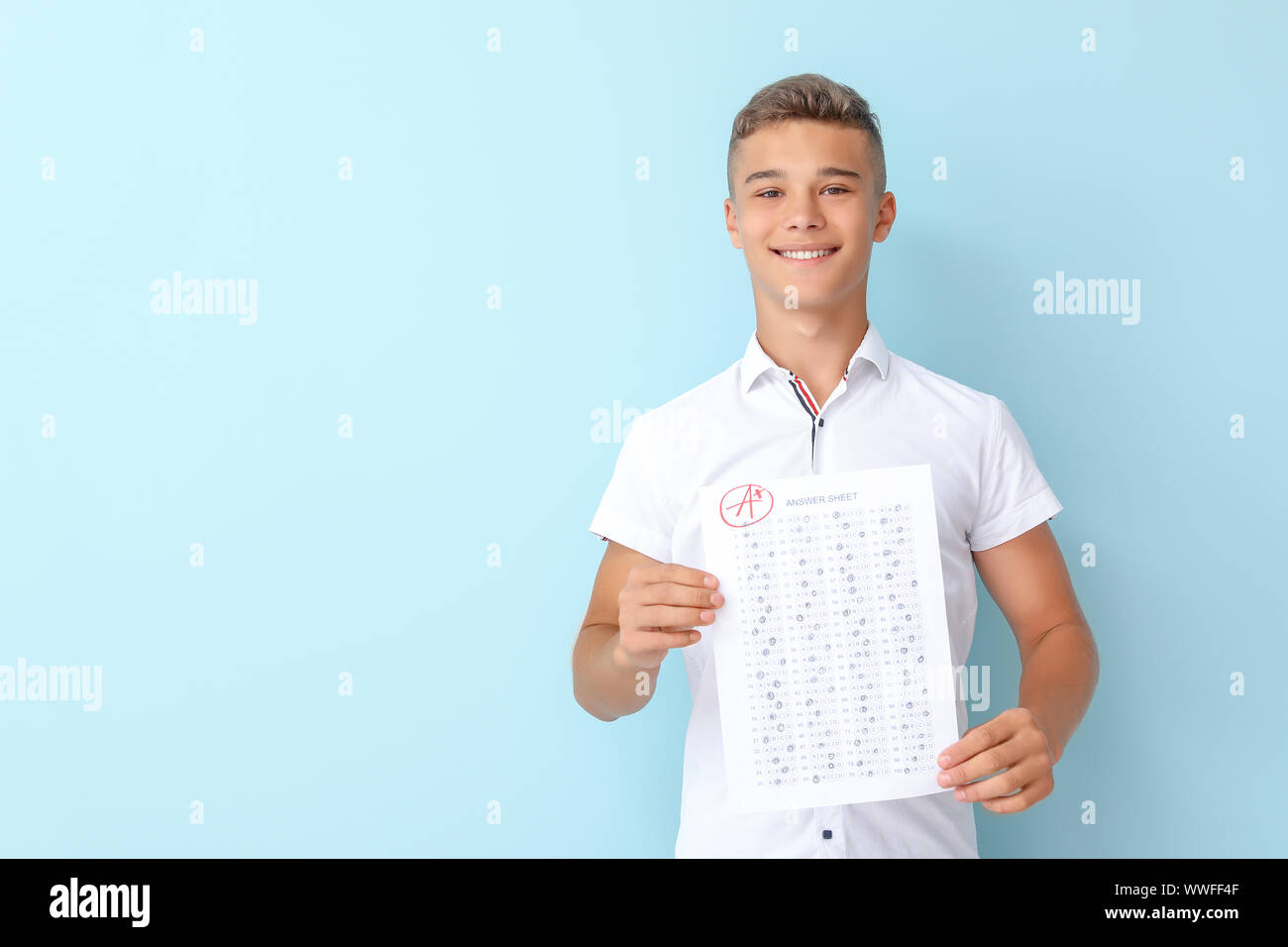 Happy boy with results of school test on color background Stock Photo ...