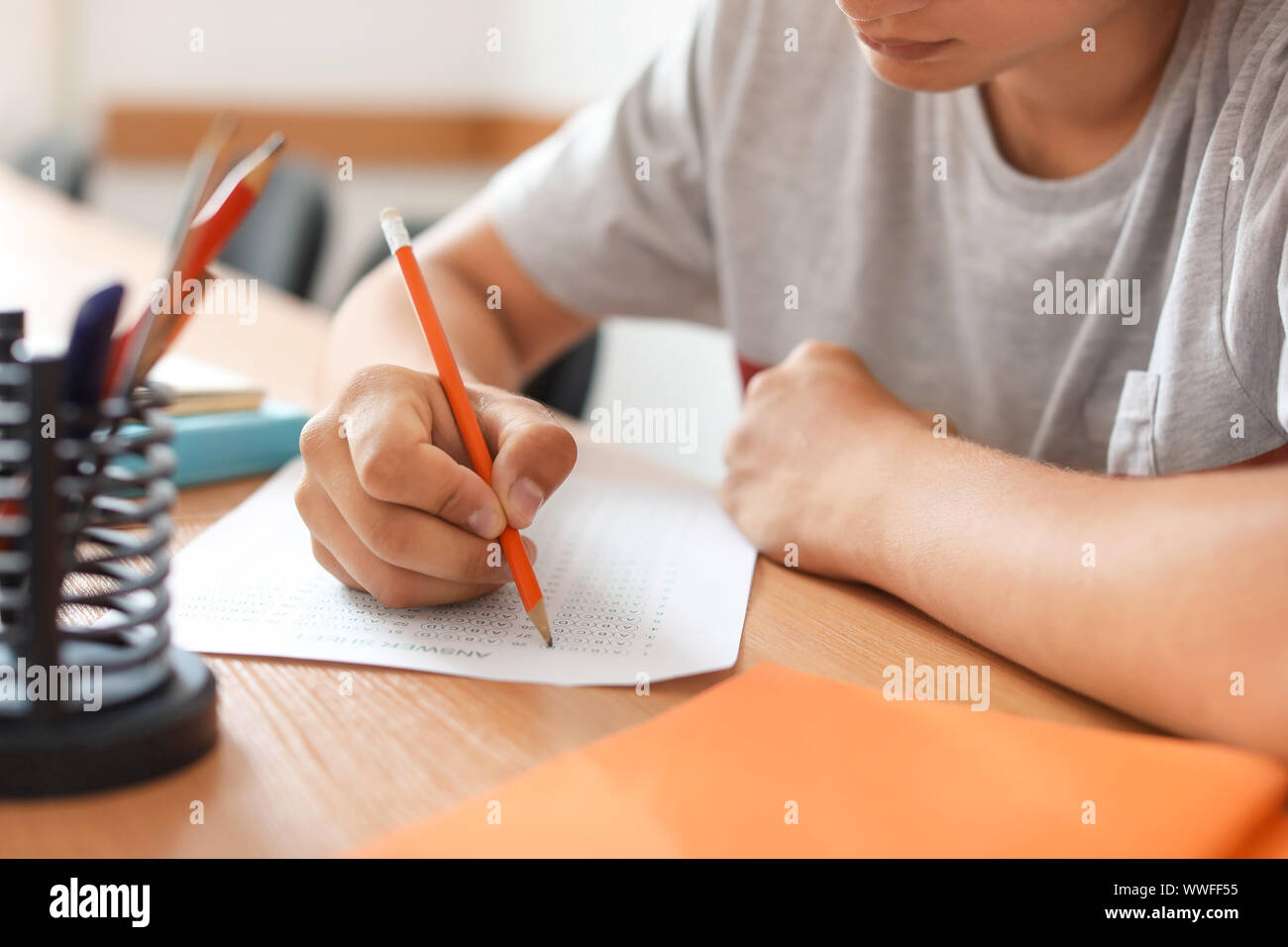 Teenage boy passing school test in classroom Stock Photo - Alamy