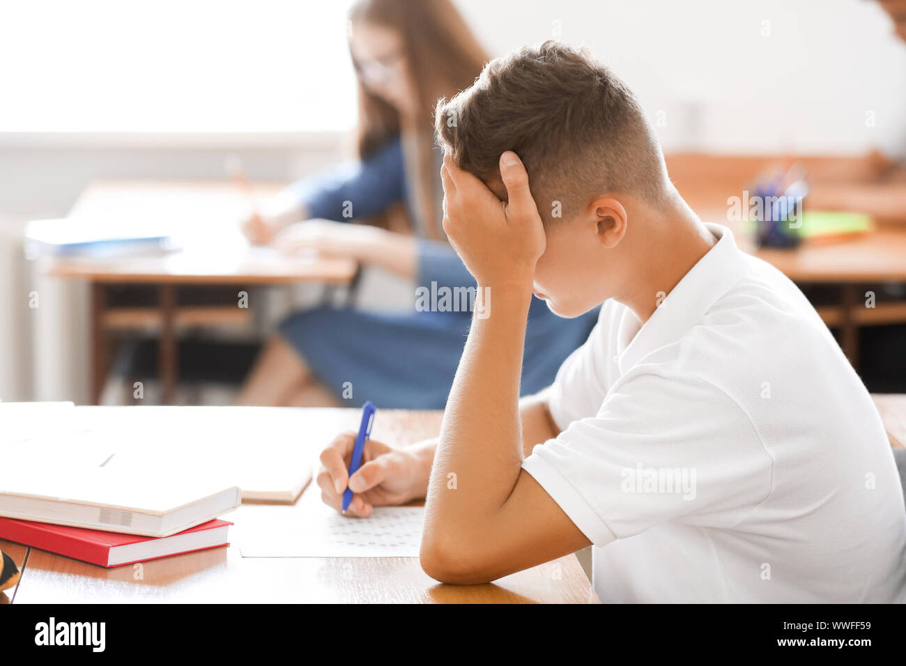 Teenage boy passing school test in classroom Stock Photo - Alamy