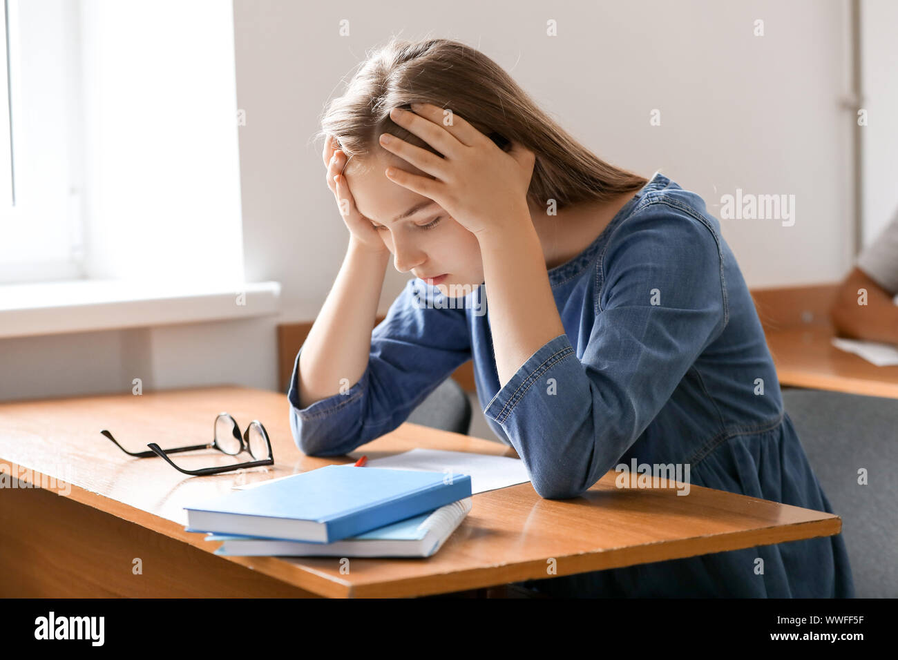 Teenage girl passing school test in classroom Stock Photo - Alamy
