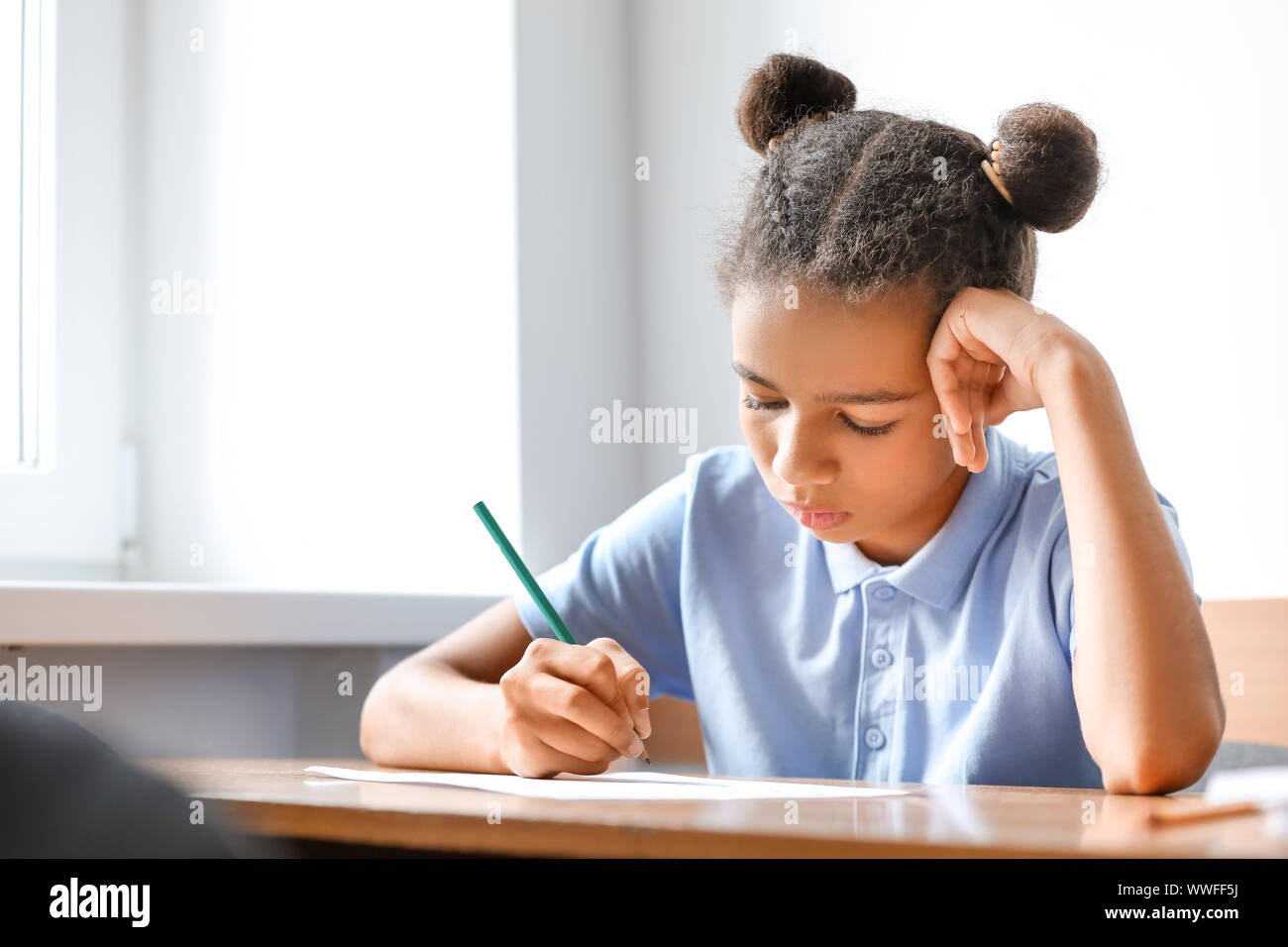 African-American teenage girl passing school test in classroom Stock ...