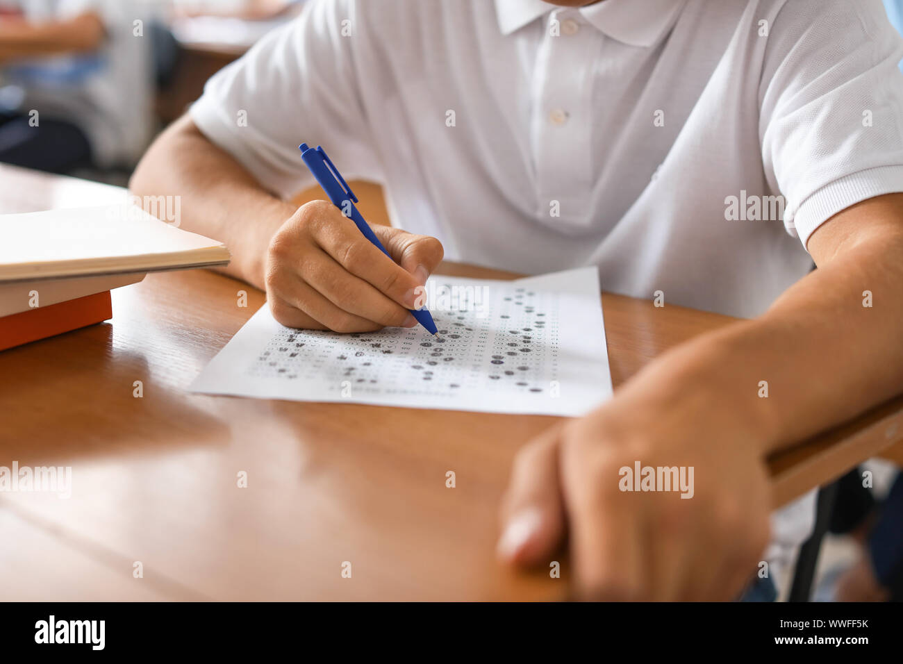 Teenage boy passing school test in classroom Stock Photo - Alamy