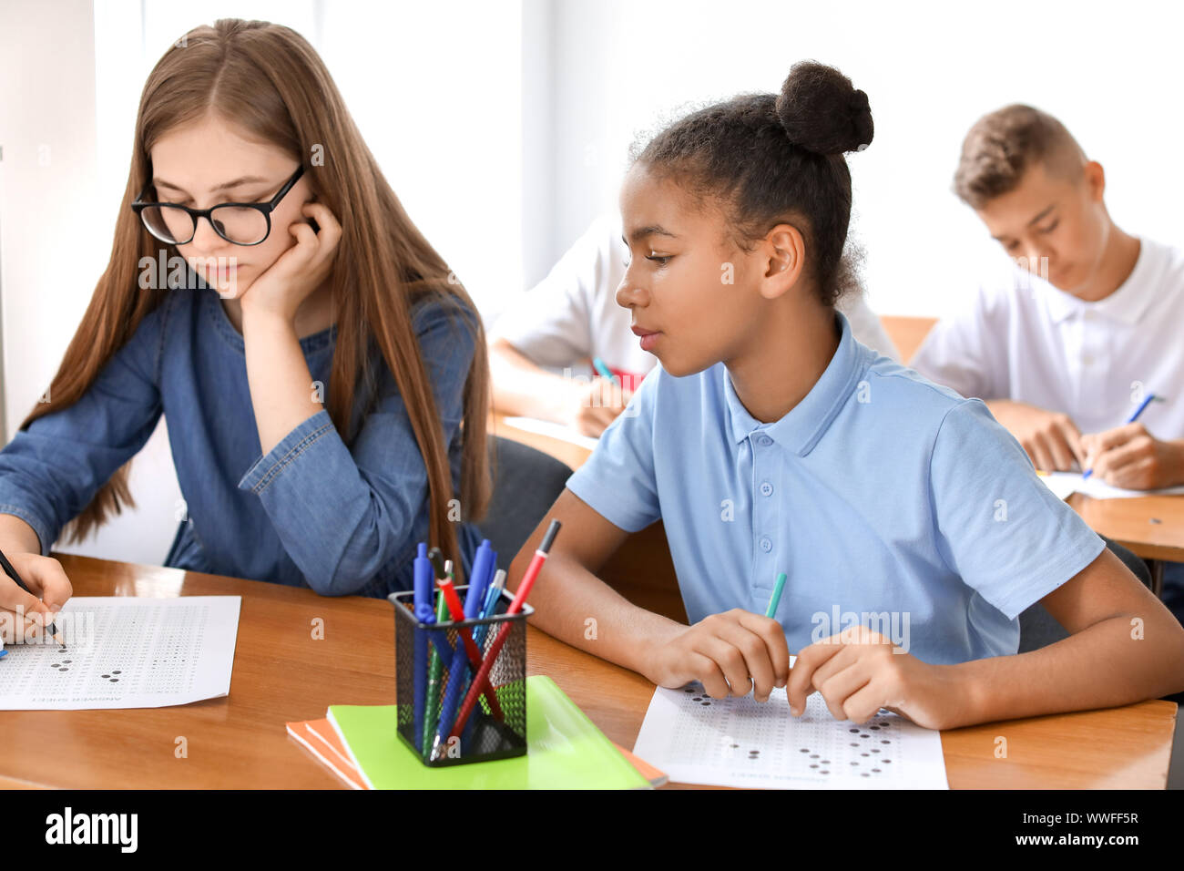 African-American girl cheating during school test in classroom Stock ...