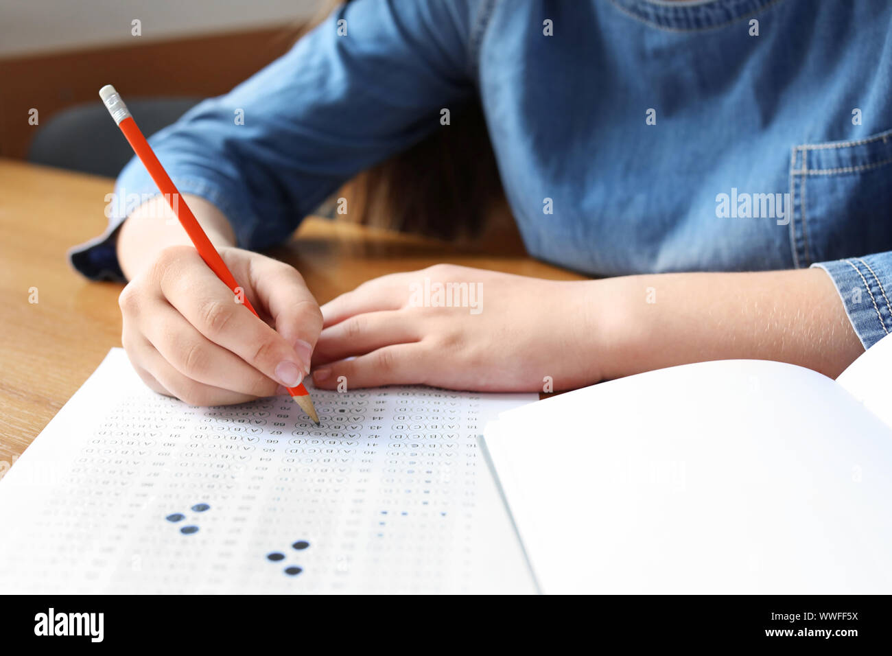 Teenage girl passing school test in classroom Stock Photo - Alamy