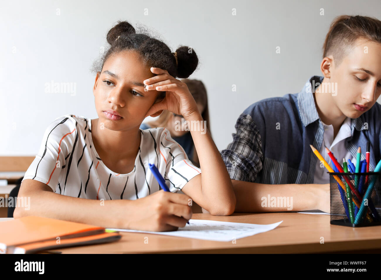 Pupils passing school test in classroom Stock Photo - Alamy