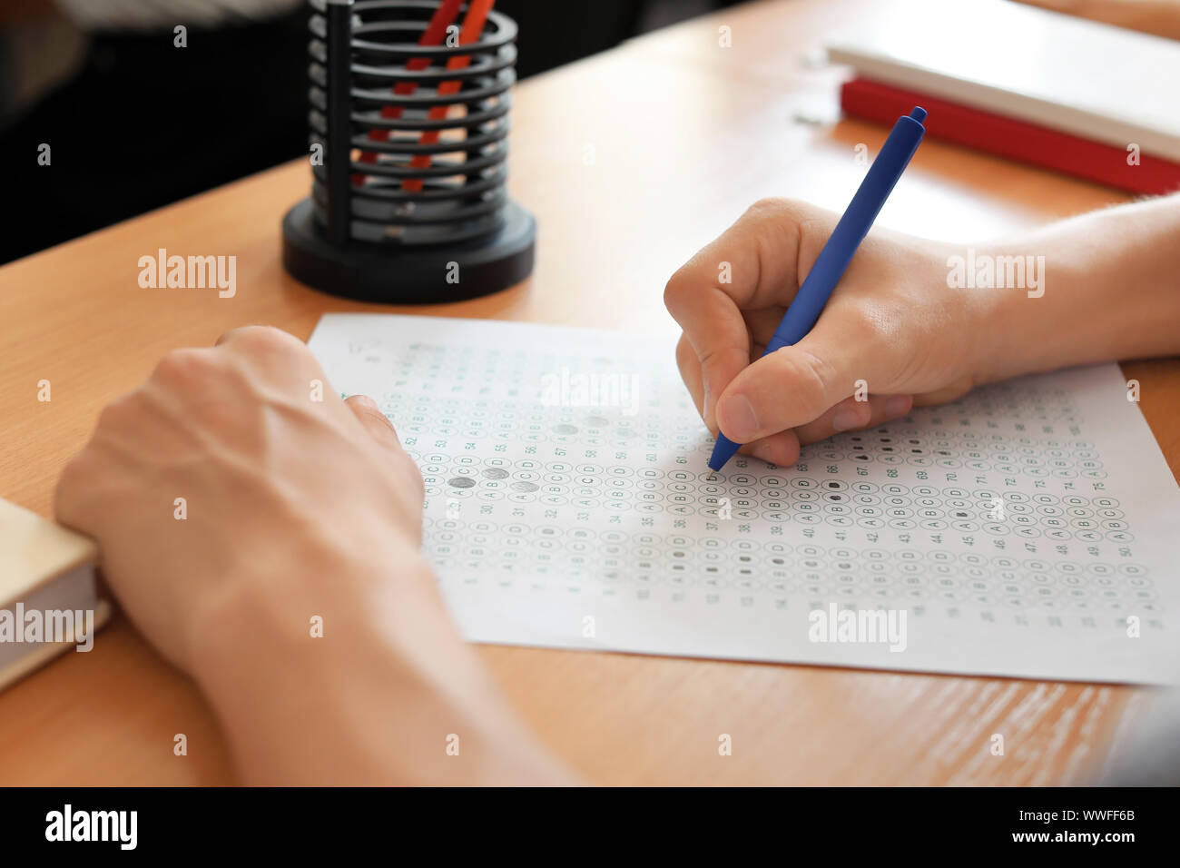 Teenage girl passing school test in classroom Stock Photo - Alamy