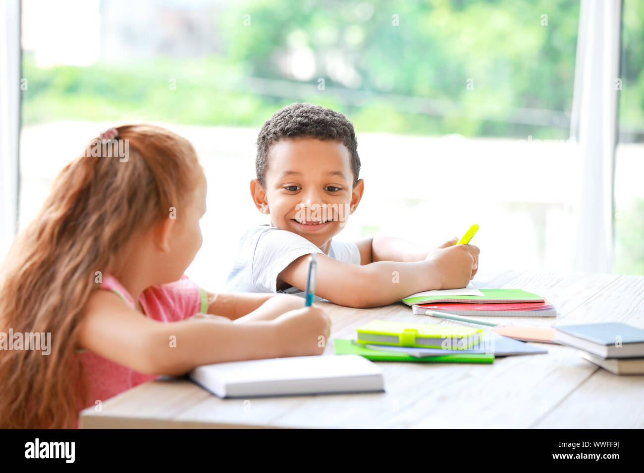 Cute little pupils during lesson in classroom Stock Photo - Alamy