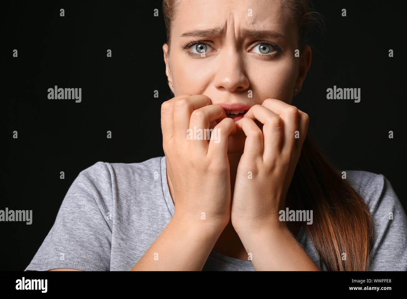 Woman having panic attack on dark background Stock Photo - Alamy