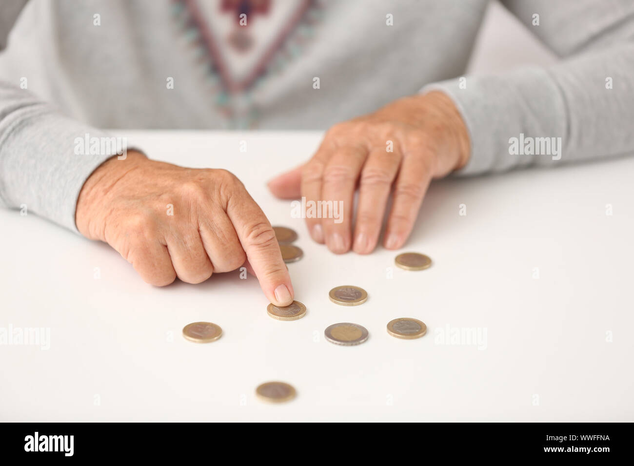 Elderly woman counting coins hi-res stock photography and images - Alamy