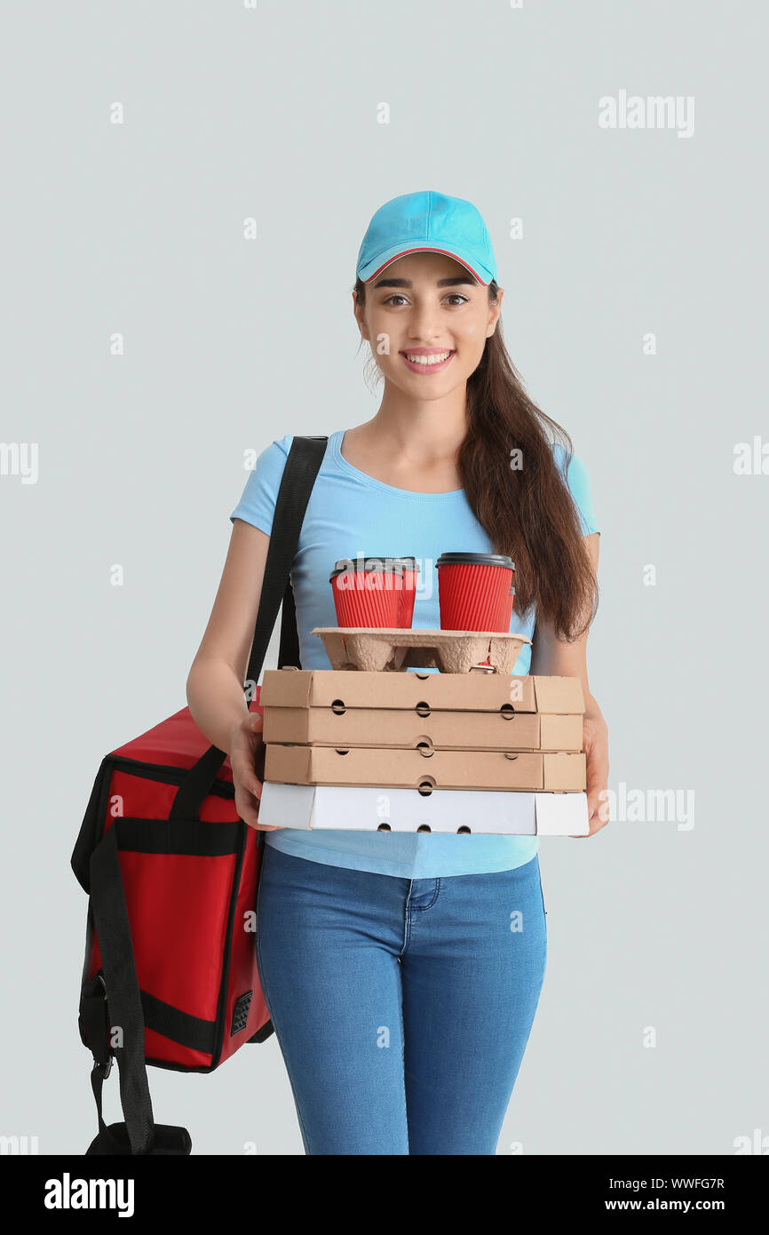 Female worker of food delivery service on white background Stock Photo ...