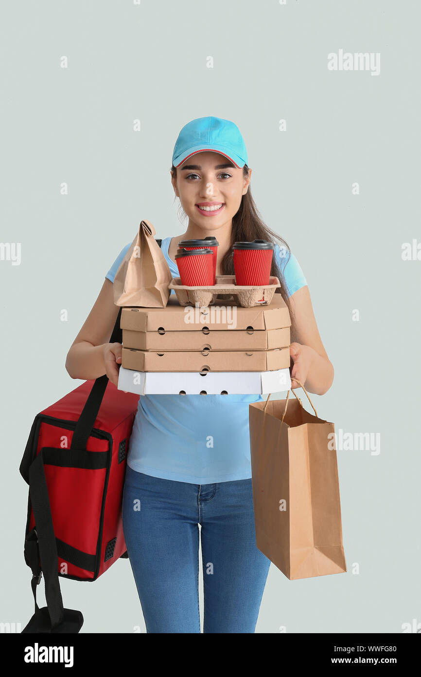 Female worker of food delivery service on white background Stock Photo ...