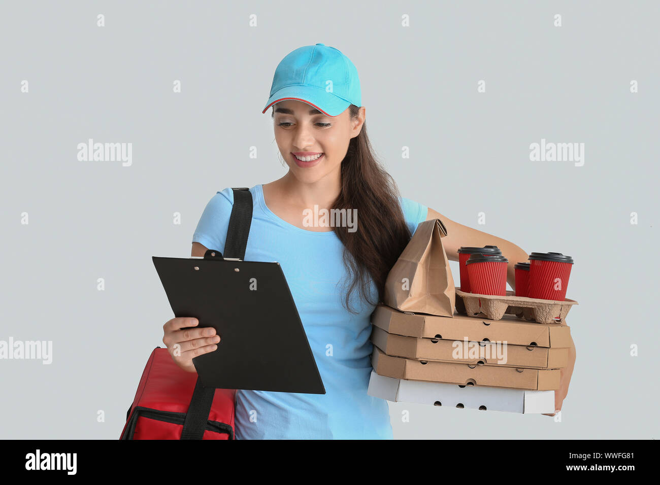 Female worker of food delivery service on white background Stock Photo ...