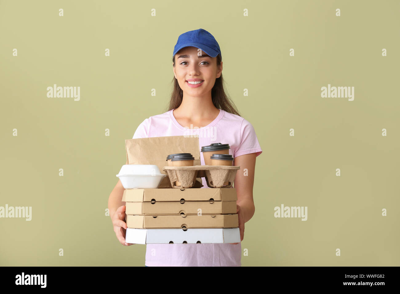 Female worker of food delivery service on color background Stock Photo ...