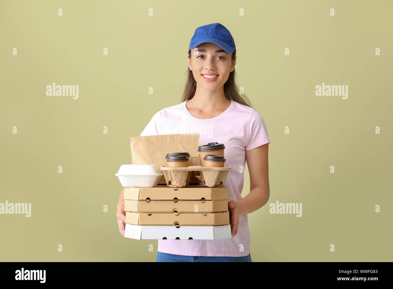 Female worker of food delivery service on color background Stock Photo - Alamy