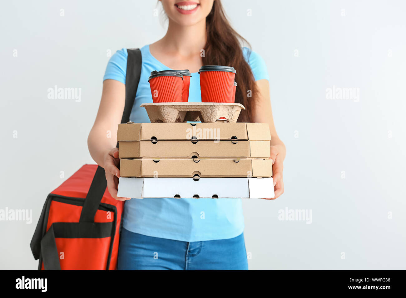 Female worker of food delivery service on white background Stock Photo ...
