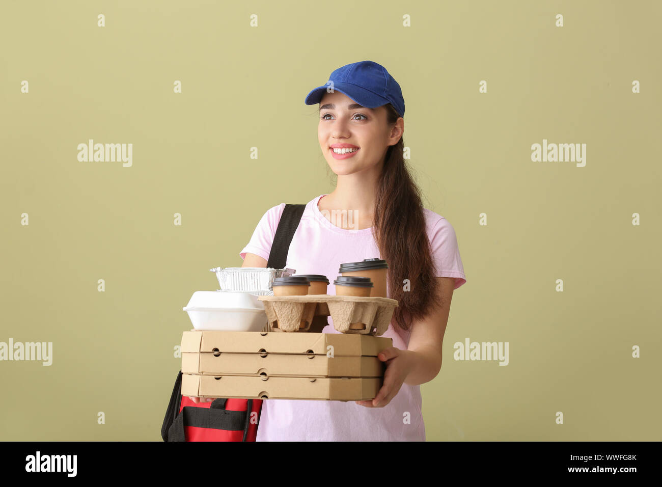 Female worker of food delivery service on color background Stock Photo ...