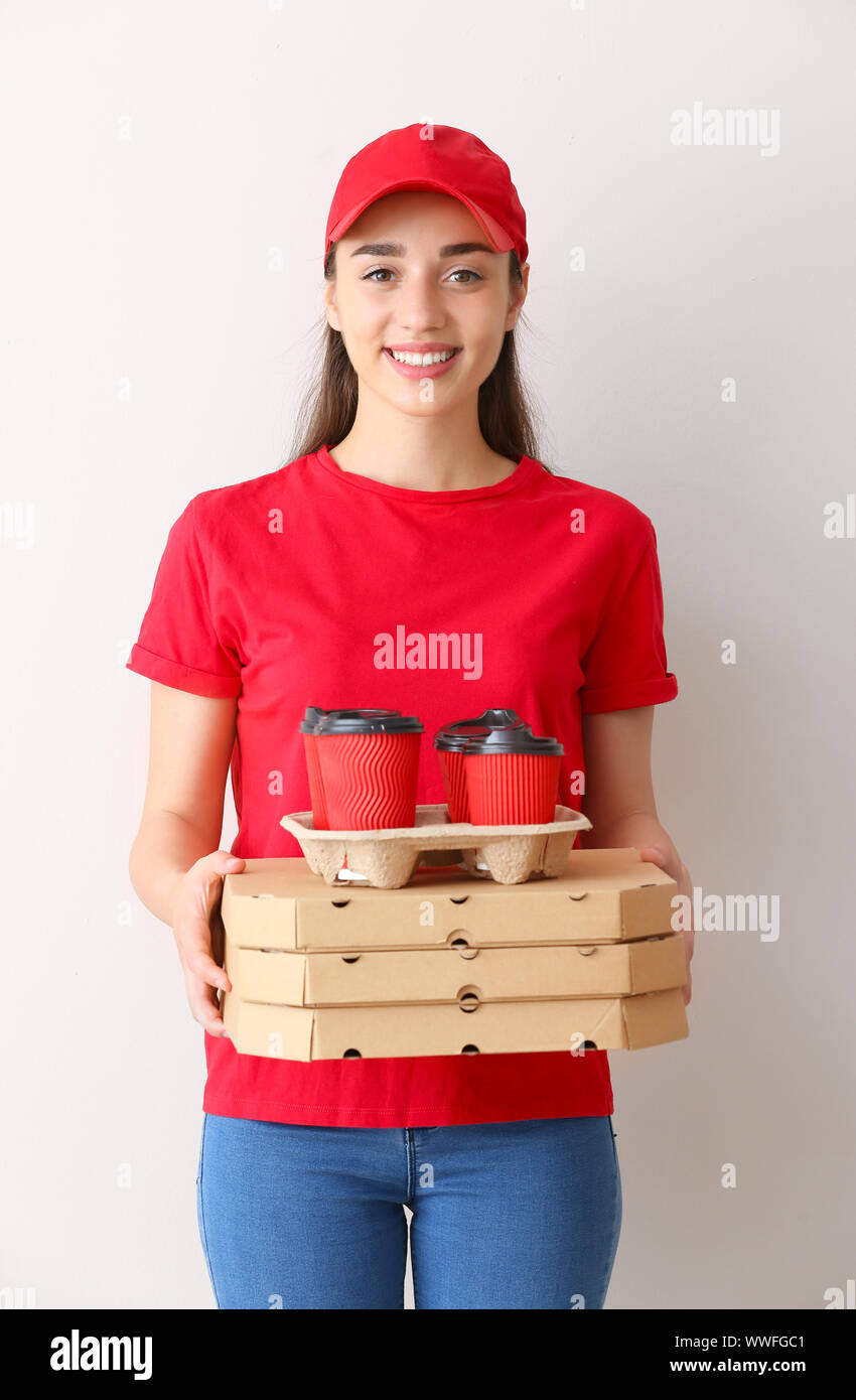 Female worker of food delivery service on white background Stock Photo ...